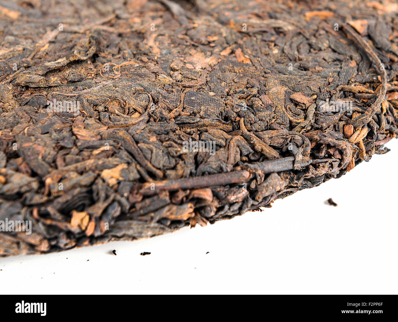 Half of chinese puer tea disc on white background Stock Photo - Alamy