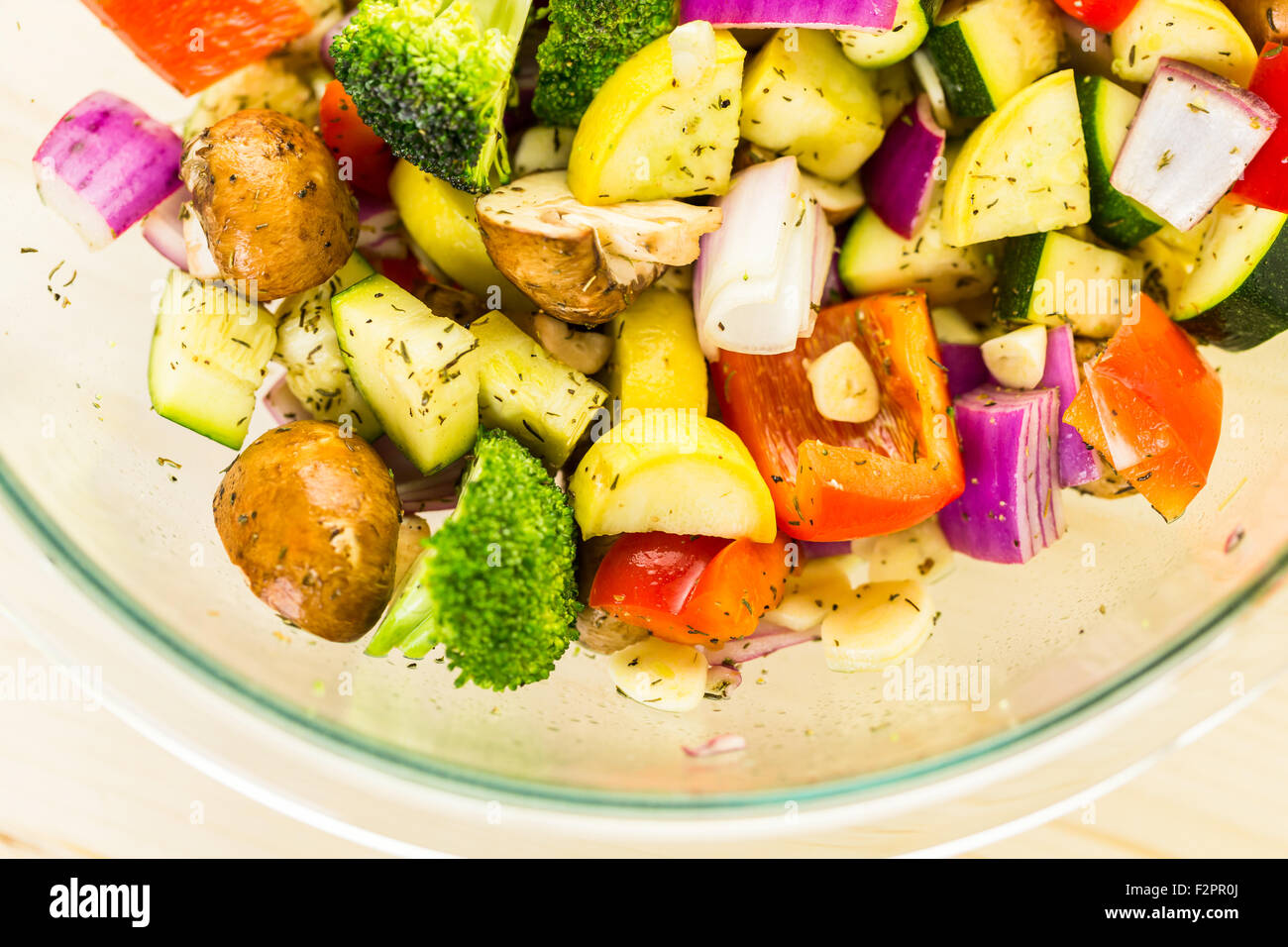 Preparing fresh roasted mixed vegetables for dinner Stock Photo - Alamy