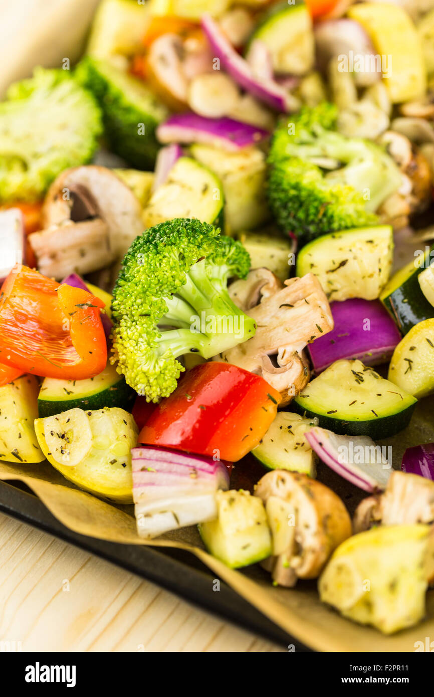 Preparing fresh roasted mixed vegetables for dinner Stock Photo - Alamy