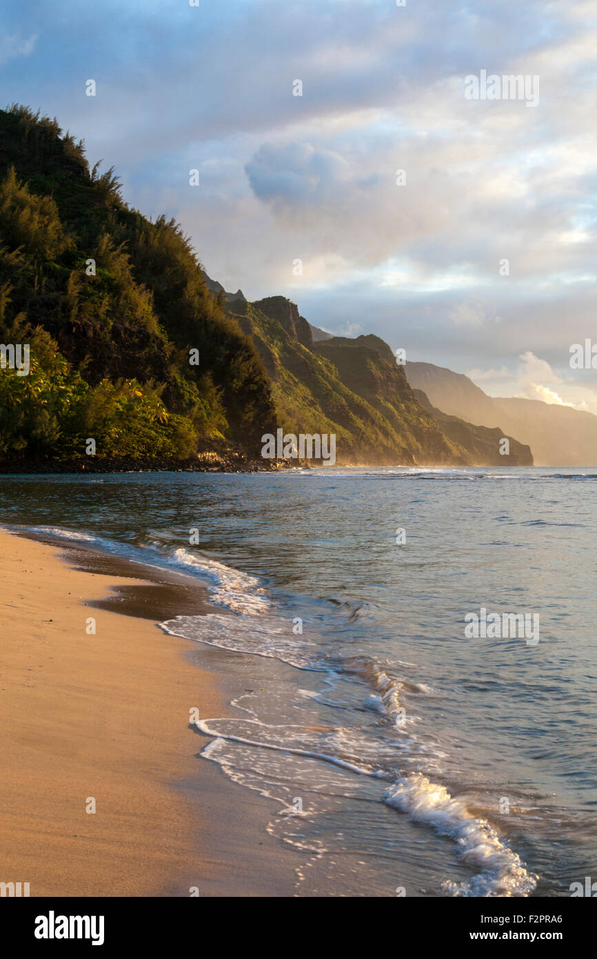 Golden light at Kee Beach and the Na Pali Coast at sunset Stock Photo ...