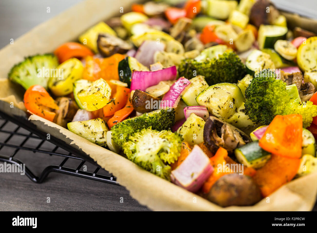 Preparing fresh roasted mixed vegetables for dinner Stock Photo - Alamy