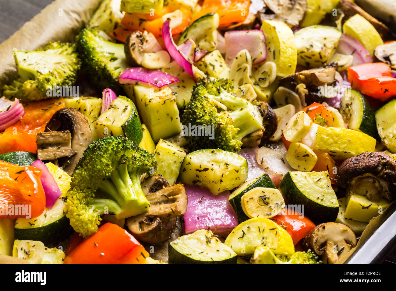 Preparing fresh roasted mixed vegetables for dinner Stock Photo - Alamy