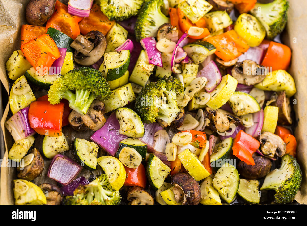 Preparing fresh roasted mixed vegetables for dinner Stock Photo - Alamy