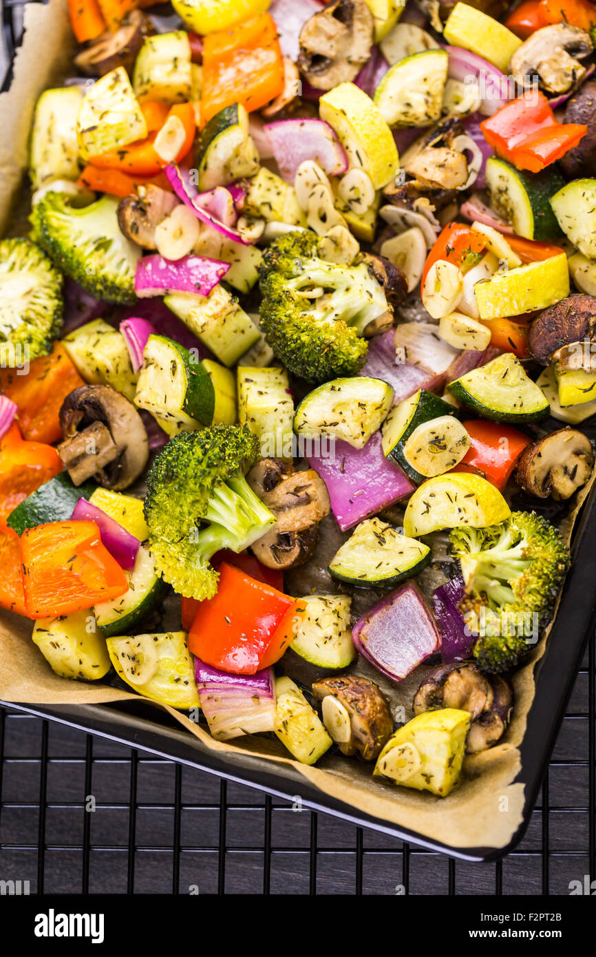 Preparing fresh roasted mixed vegetables for dinner Stock Photo - Alamy