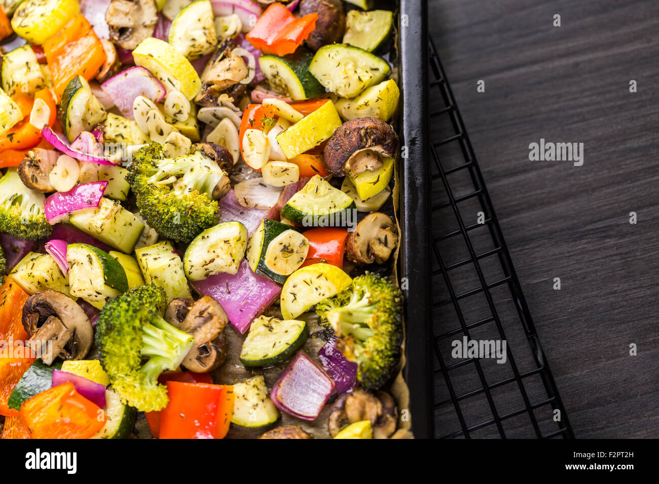 Preparing fresh roasted mixed vegetables for dinner Stock Photo - Alamy