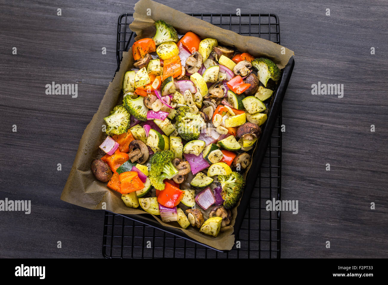 Preparing fresh roasted mixed vegetables for dinner Stock Photo - Alamy