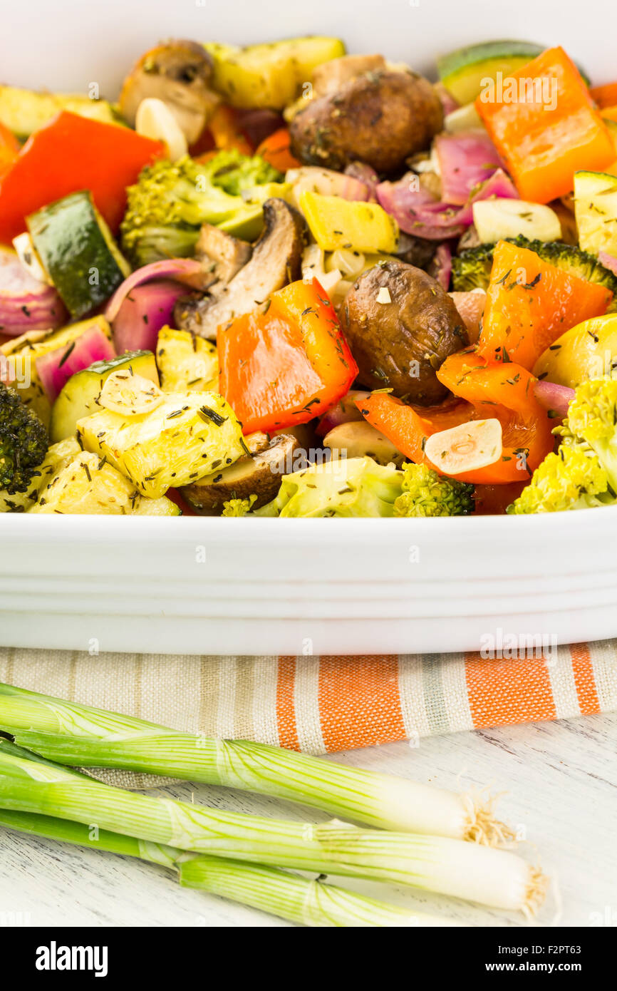 Preparing fresh roasted mixed vegetables for dinner Stock Photo - Alamy