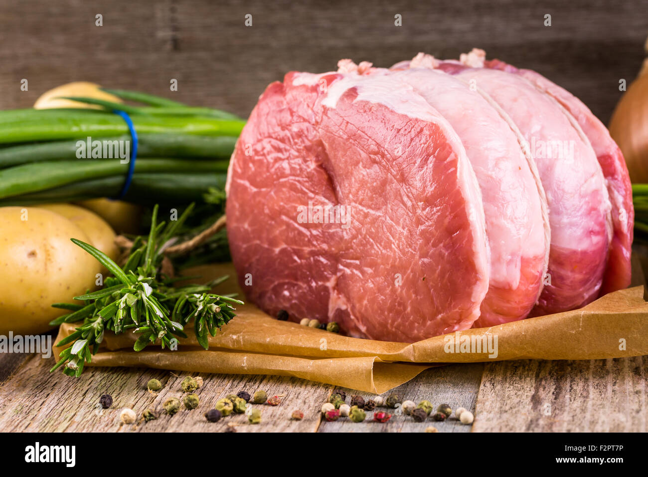 Organic pork lion roast with rosemary on wood farm table Stock Photo ...