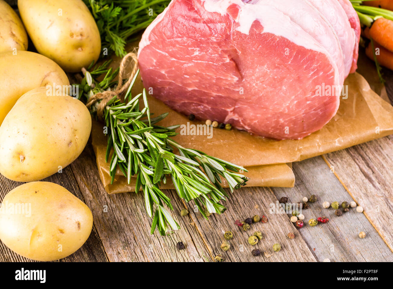 Organic pork lion roast with rosemary on wood farm table Stock Photo ...