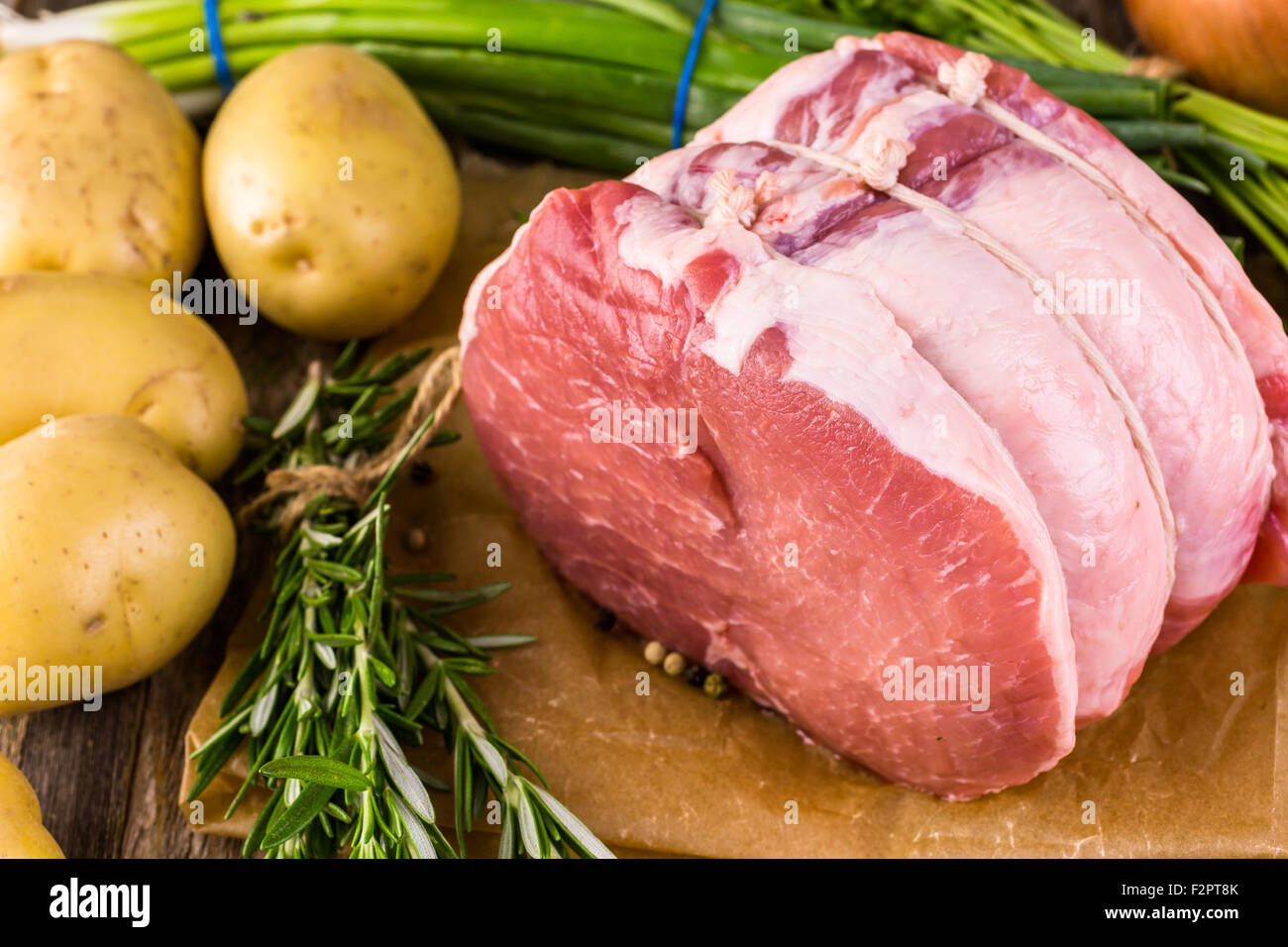 Organic pork lion roast with rosemary on wood farm table Stock Photo ...