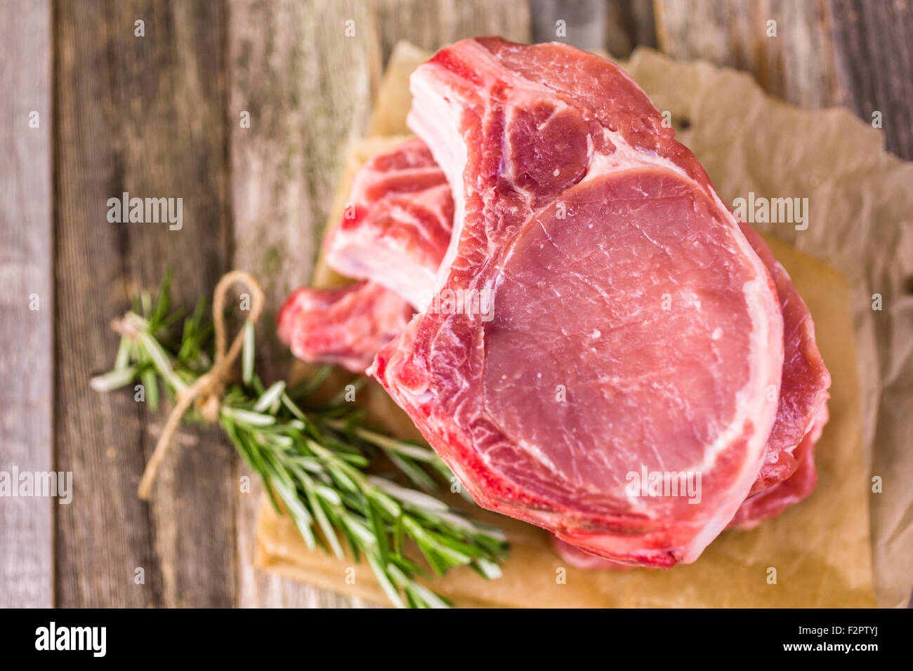 Organic pork lion chops of thick cut with rosemary Stock Photo - Alamy