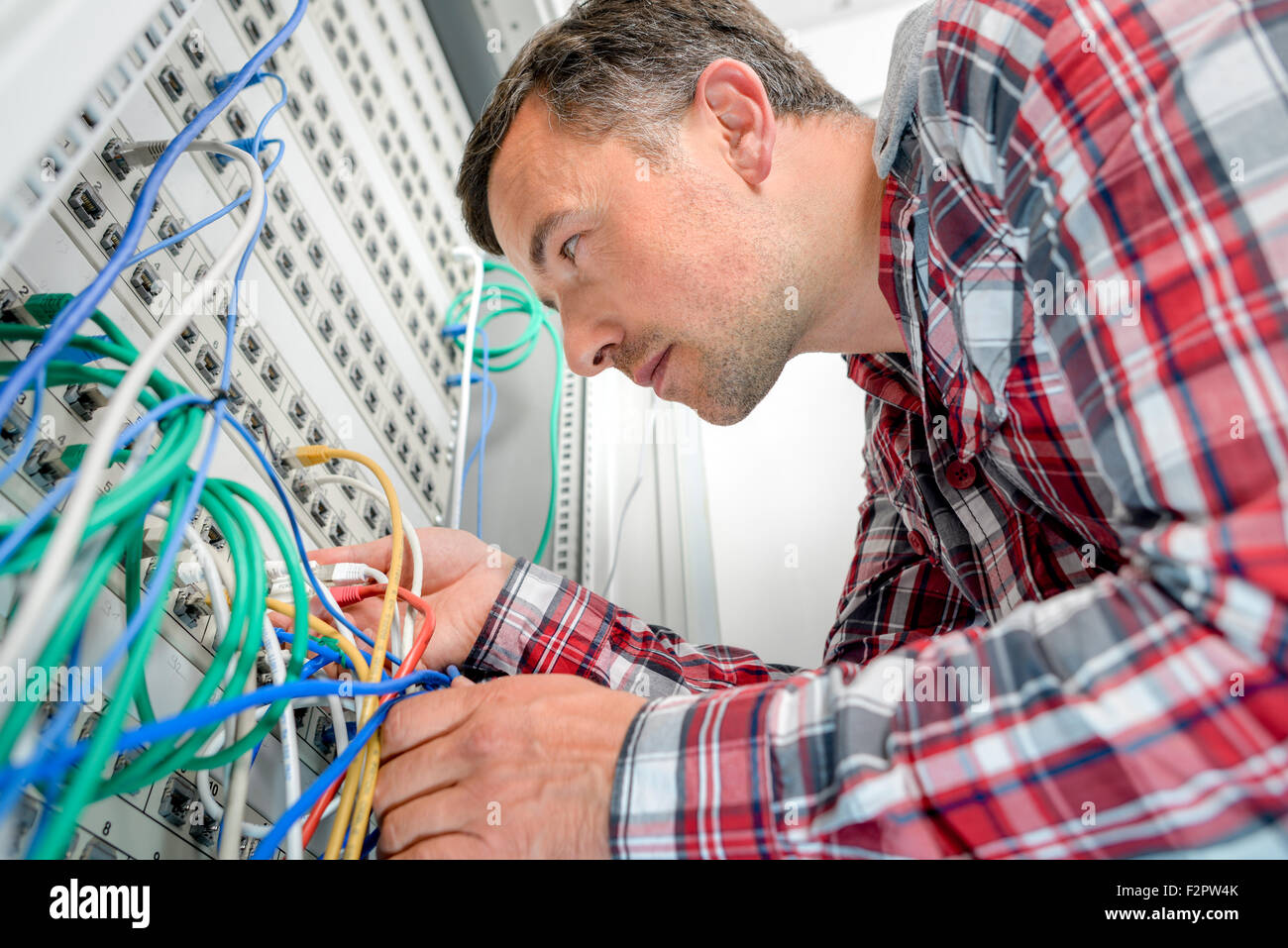 Electrician connecting cables Stock Photo - Alamy