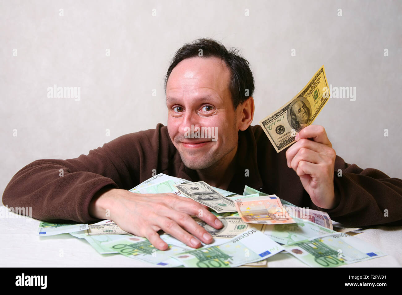 The adult the man with a heap of money Stock Photo - Alamy