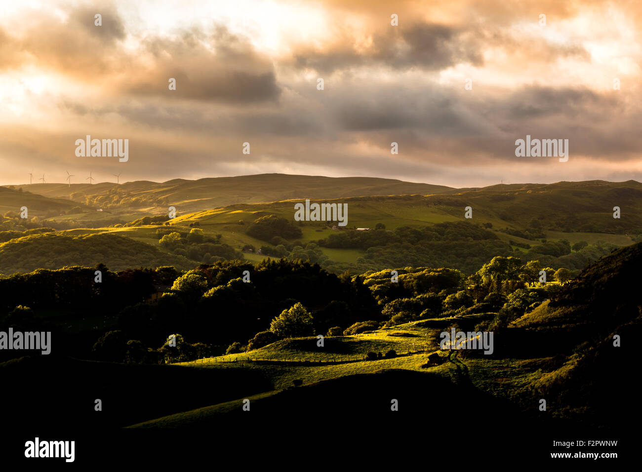 Sun setting over the cambrian mountains casting rays across the land ...