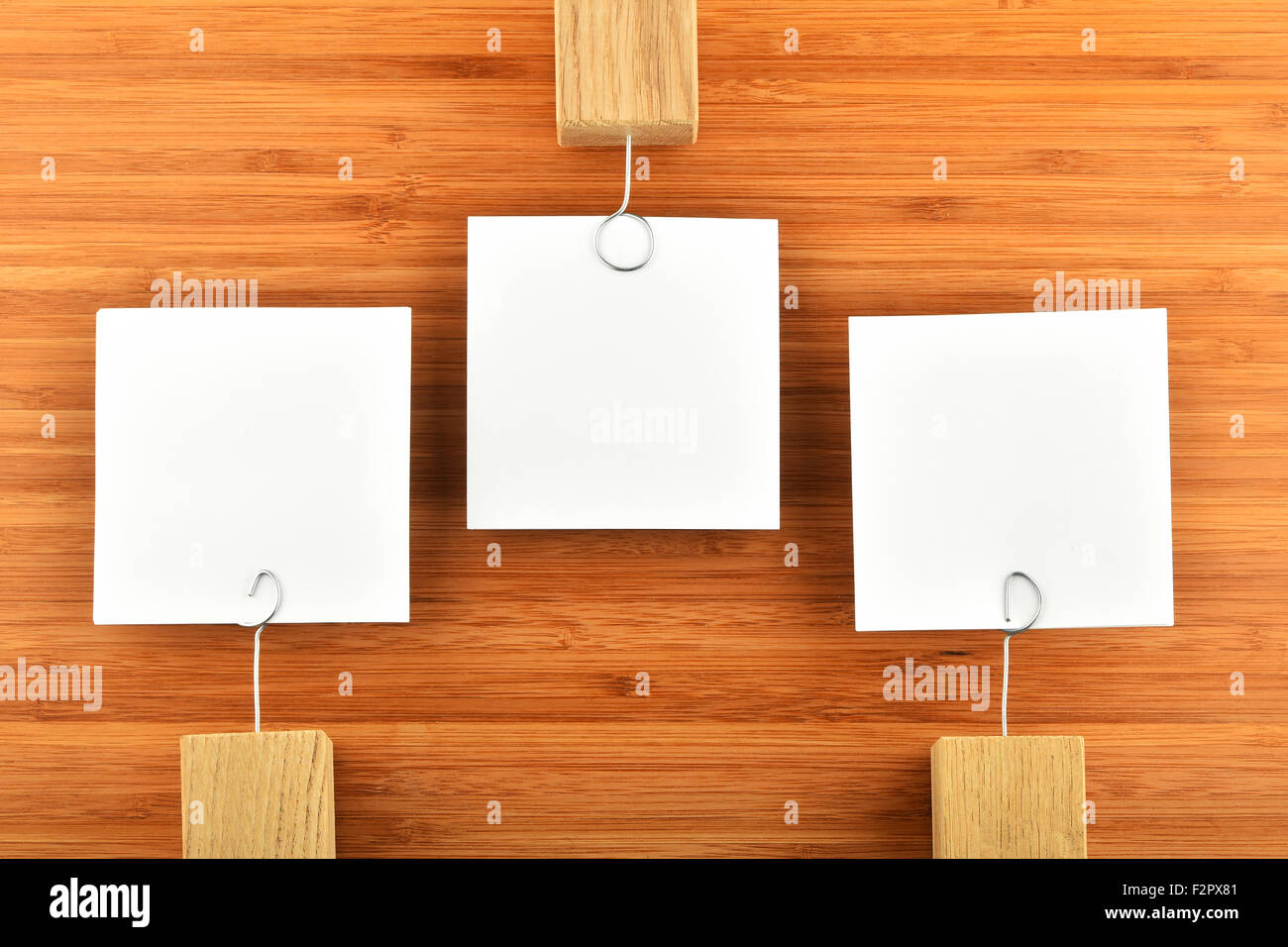 Opposite Opinion - three white paper notes with wooden holders in ...
