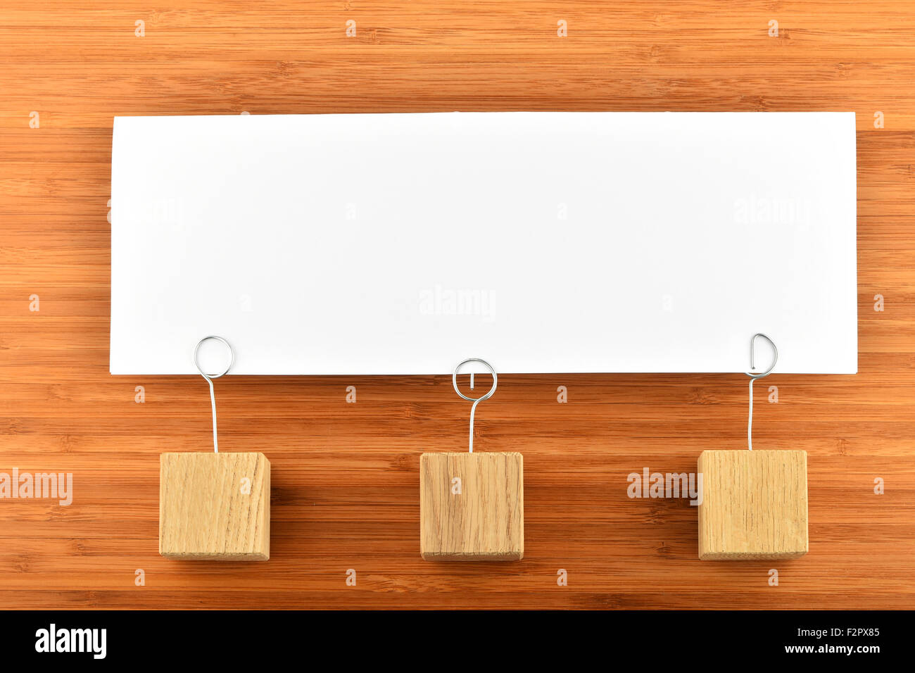 Together, one big white paper note with three wooden holders on wooden ...