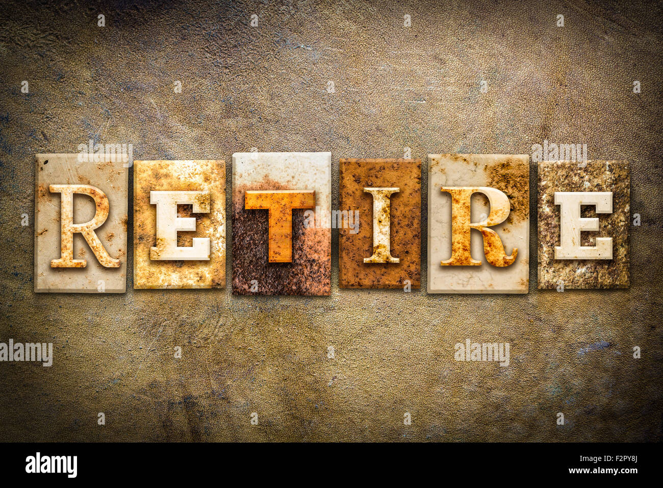The word "RETIRE" written in rusty metal letterpress type on an old ...