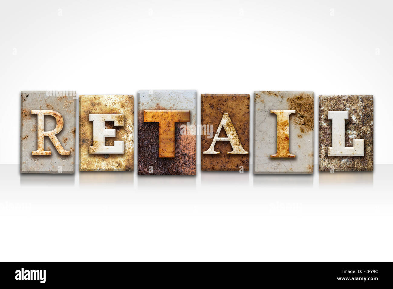 The word "RETAIL" written in rusty metal letterpress type isolated on a ...