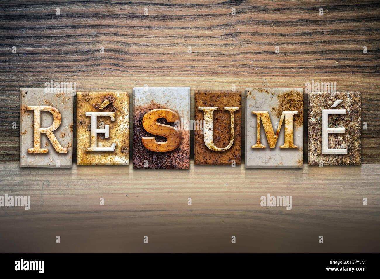 The word "RESUME" written in rusty metal letterpress type sitting on a ...