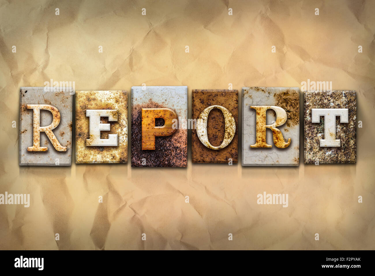 The word "REPORT" written in rusty metal letterpress type on a crumbled ...