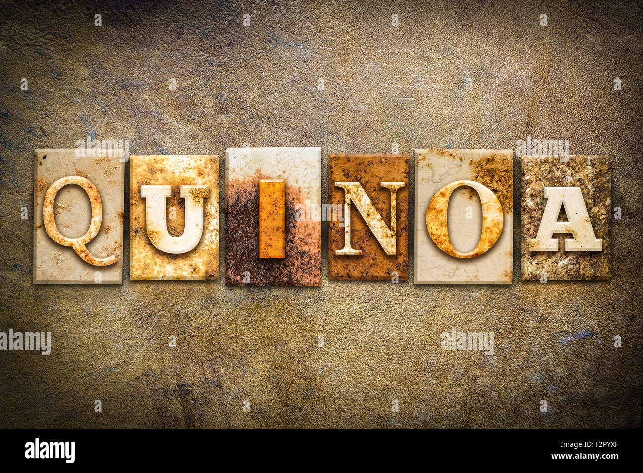The word "QUINOA" written in rusty metal letterpress type on an old ...