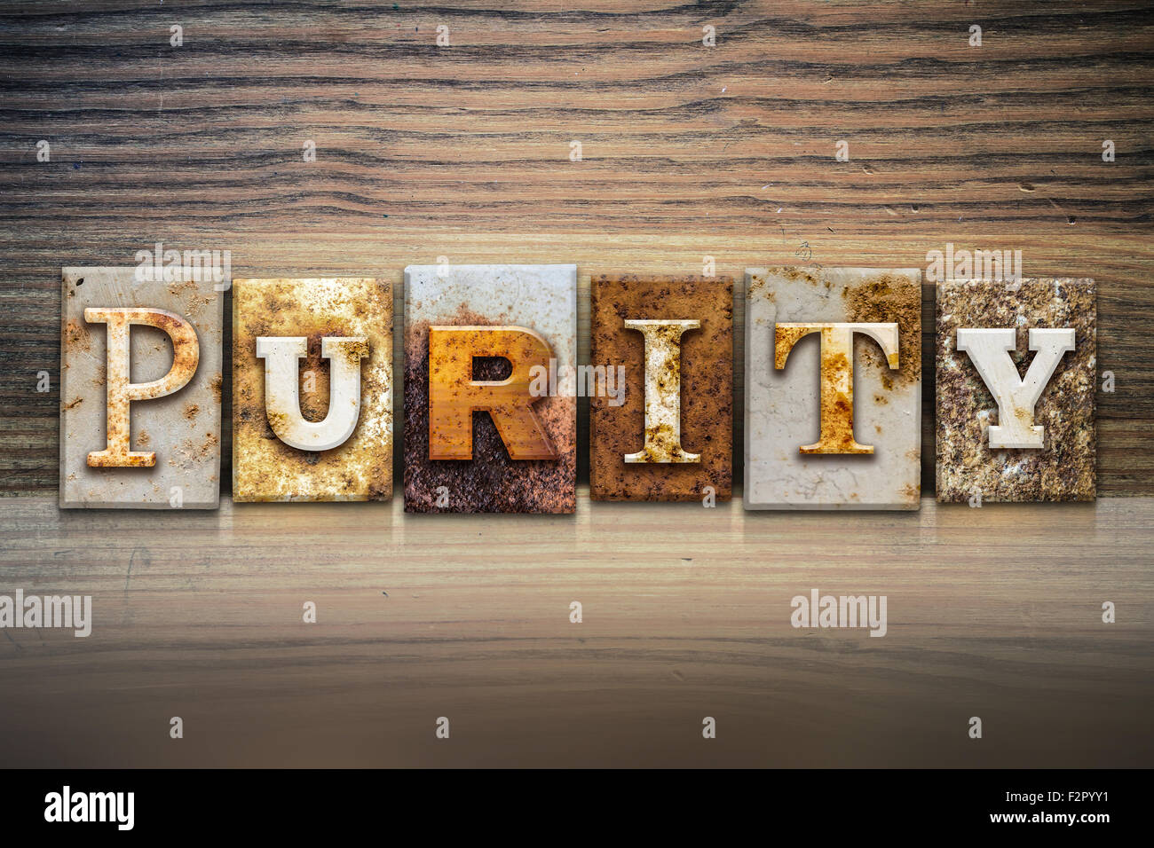 The word "PURITY" written in rusty metal letterpress type sitting on a ...