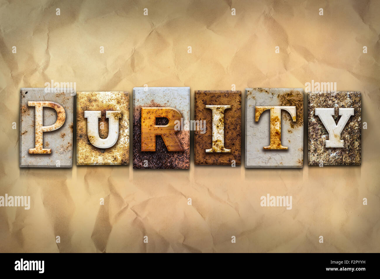 The word "PURITY" written in rusty metal letterpress type on a crumbled ...