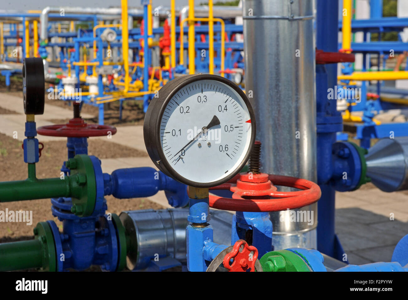 Pressure meter and red faucet with steel yellow pipe in natural gas ...