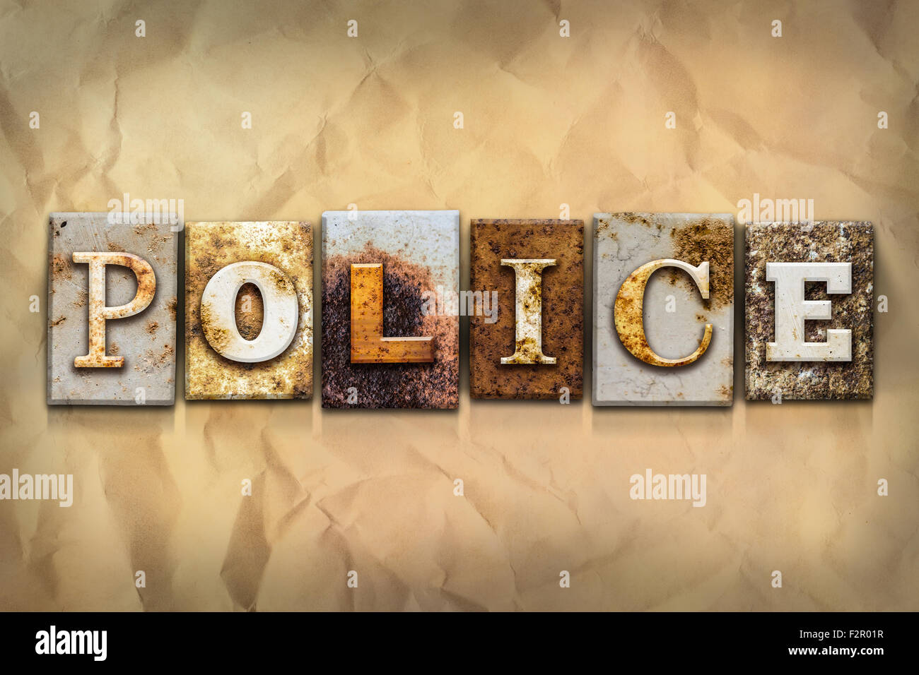 The word "POLICE" written in rusty metal letterpress type on a crumbled ...