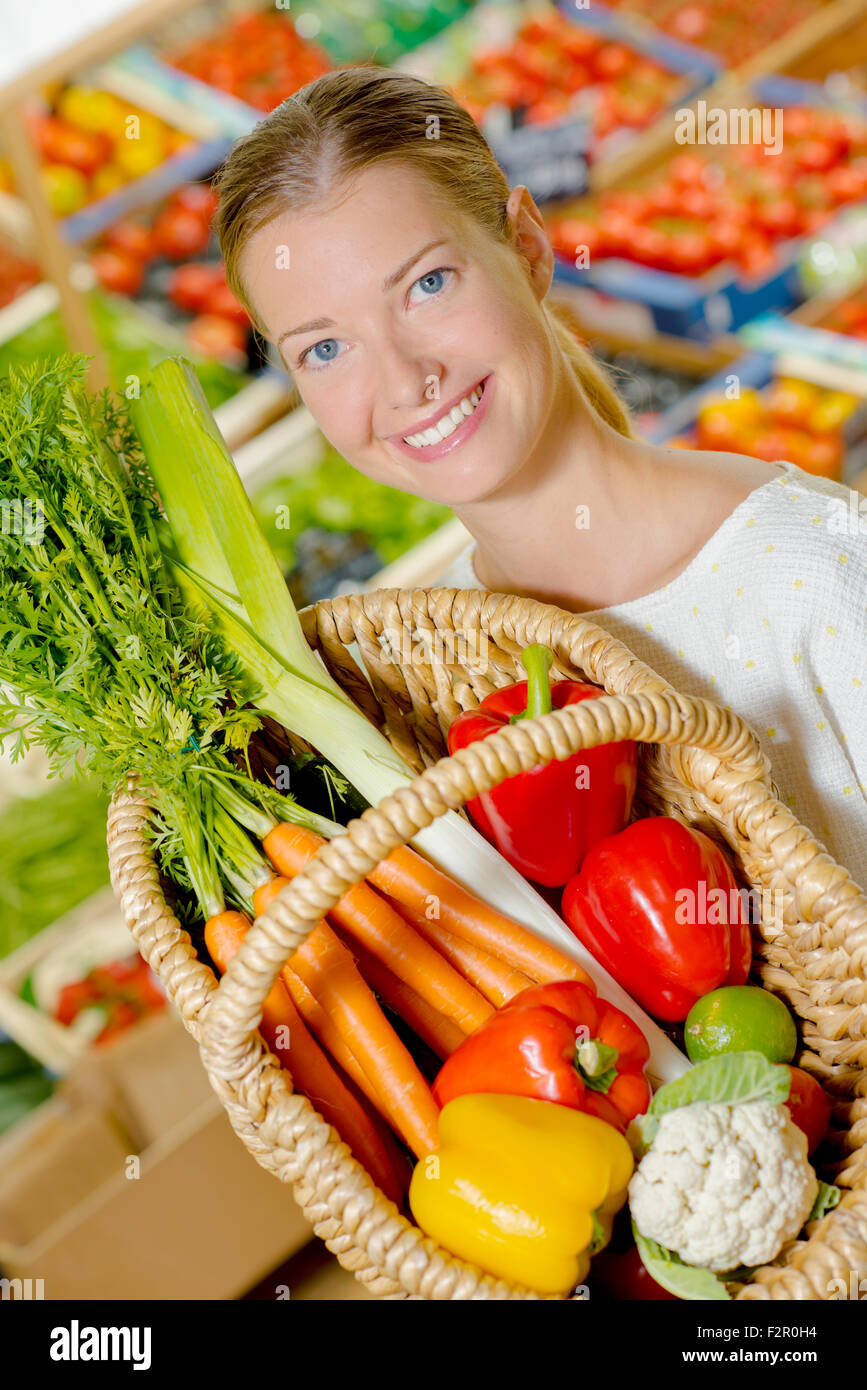 Lady showing basket full of fruit and vegetables Stock Photo - Alamy