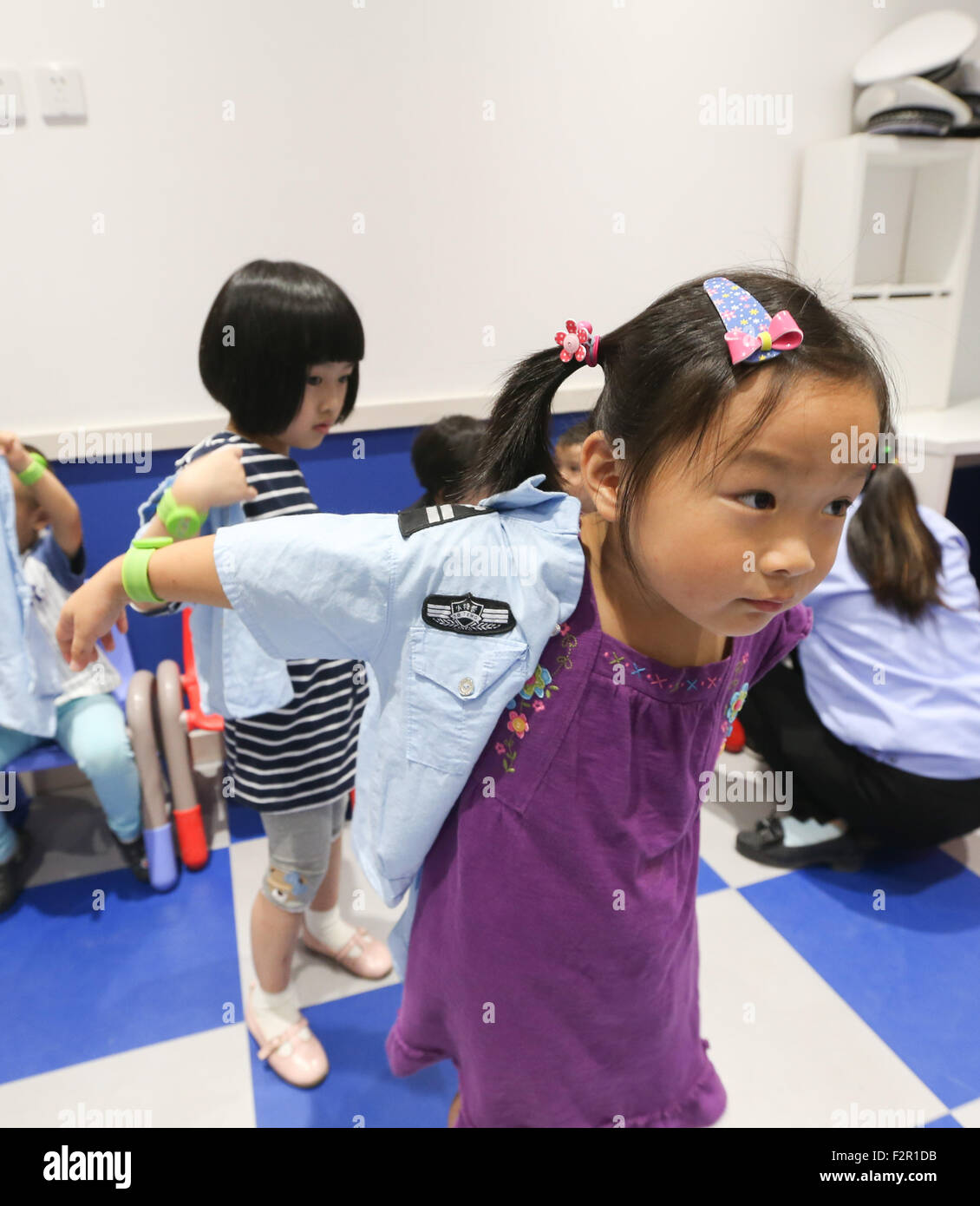 Shanghai, China. 20th Sep, 2015. A child acts as a policewoman at a ...