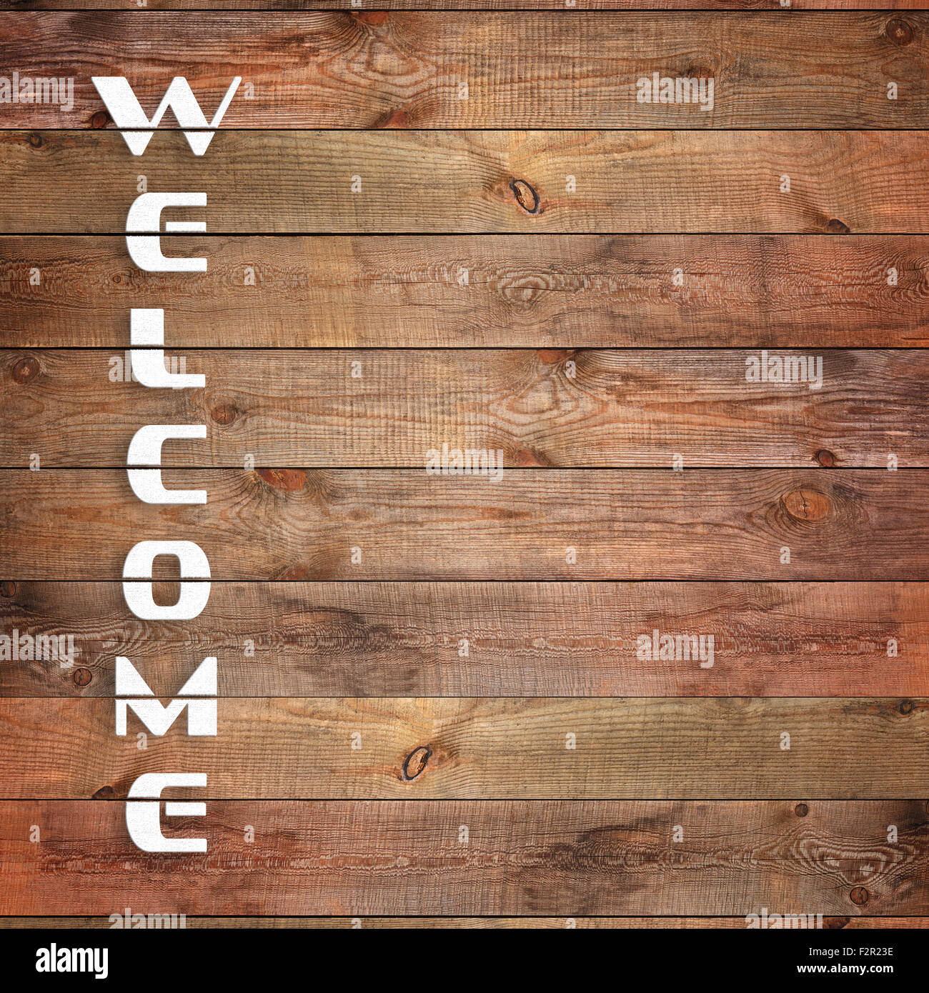 Vintage WELCOME sign on natural wooden surface. Closeup Stock Photo - Alamy