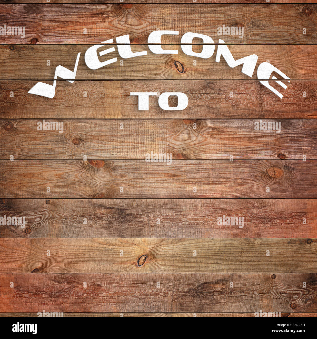 Vintage WELCOME TO sign on natural wooden surface. Closeup Stock Photo ...