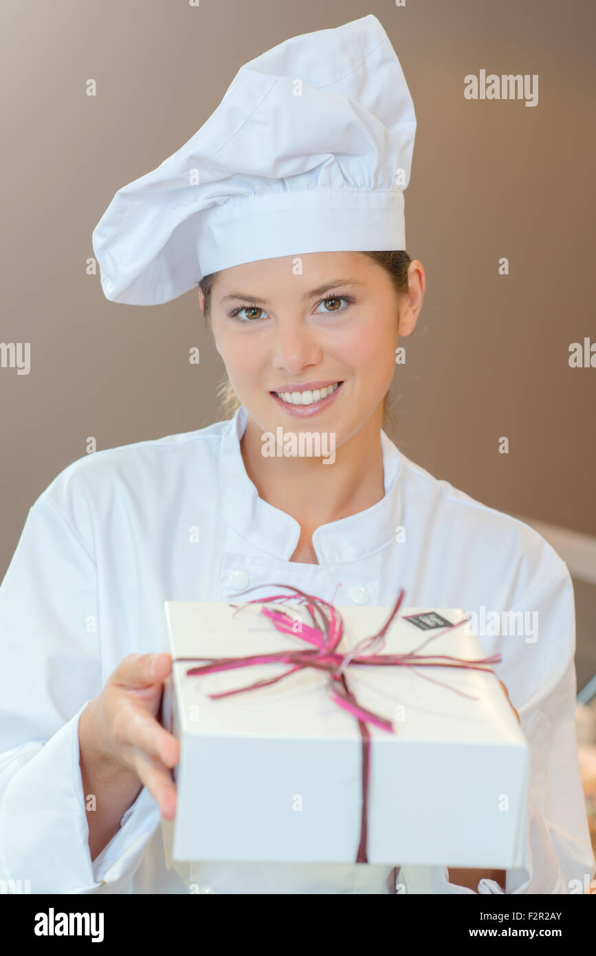 Patisserie chef holding a gift box Stock Photo - Alamy