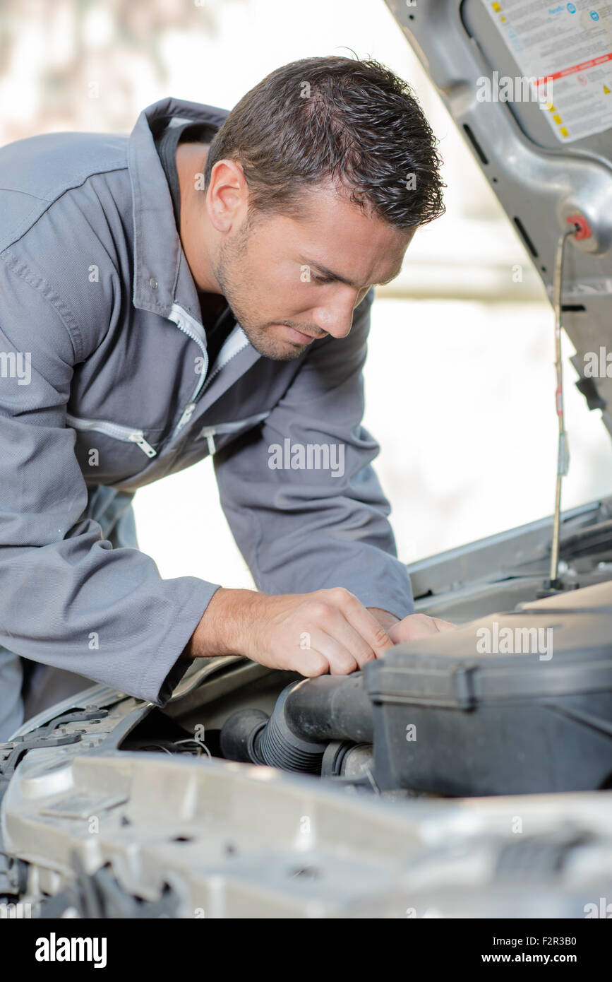 Mechanic repairing an engine Stock Photo - Alamy