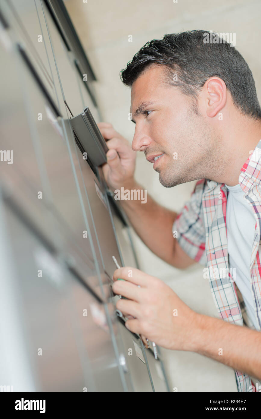 Man checking his letter box Stock Photo - Alamy