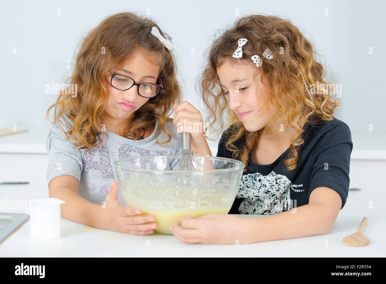Two sisters baking Stock Photo - Alamy