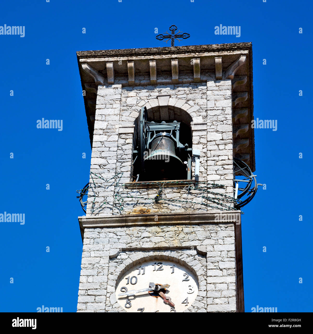 ancien clock tower in italy europe old stone and bell Stock Photo - Alamy