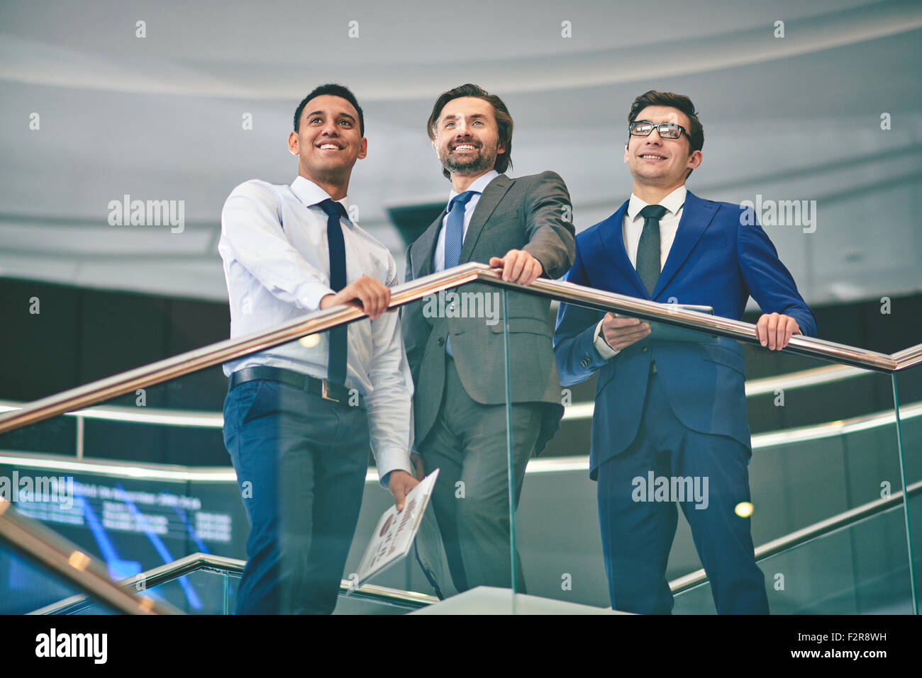 Group of elegant businessmen gathered at meeting Stock Photo - Alamy