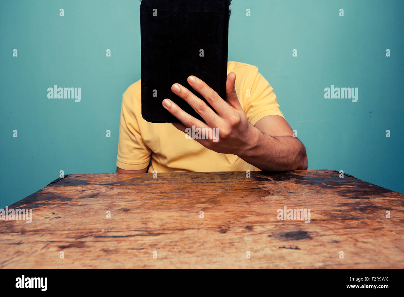 Young man using tablet at table Stock Photo - Alamy