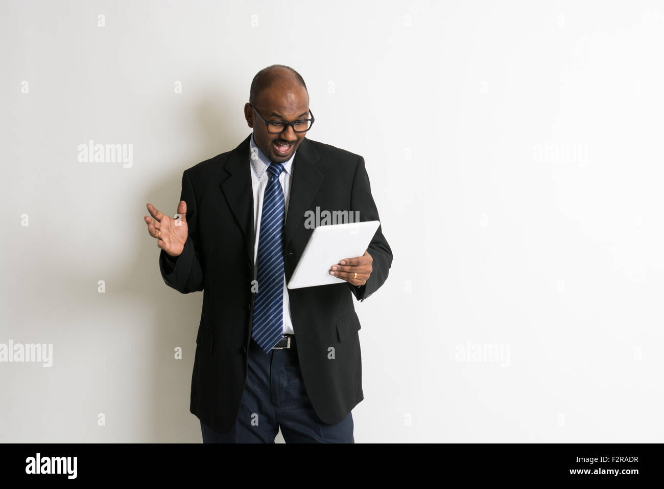 indian businessman with tablet shouting and shock Stock Photo - Alamy