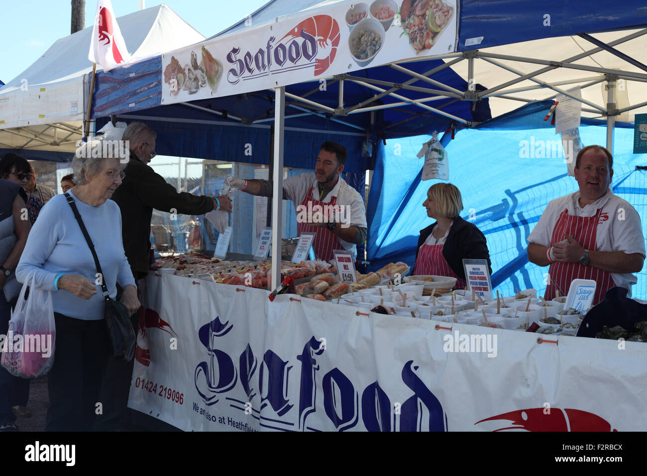 A couple buying fresh local fish at the Seafood Festival on the Stade ...