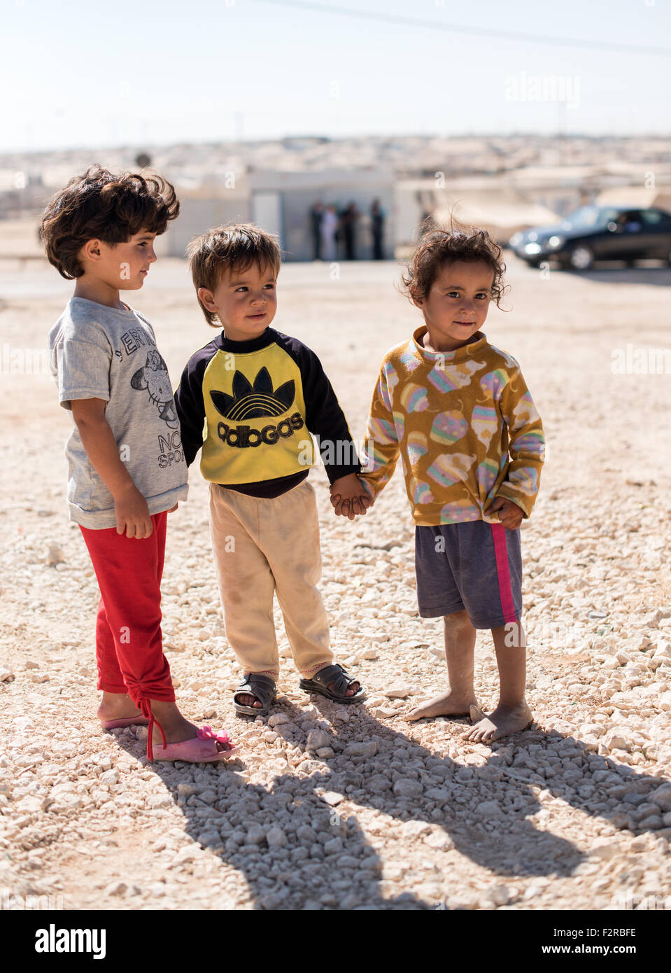 Refugee children from Syria stand together holding hands at the refugee ...