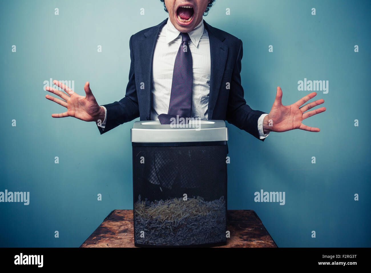 Businessman Has Got His Tie Stuck In A Paper Shredder Stock Photo Alamy businessman-has-got-his-tie-stuck-in-a-paper-shredder-stock-photo-alamy