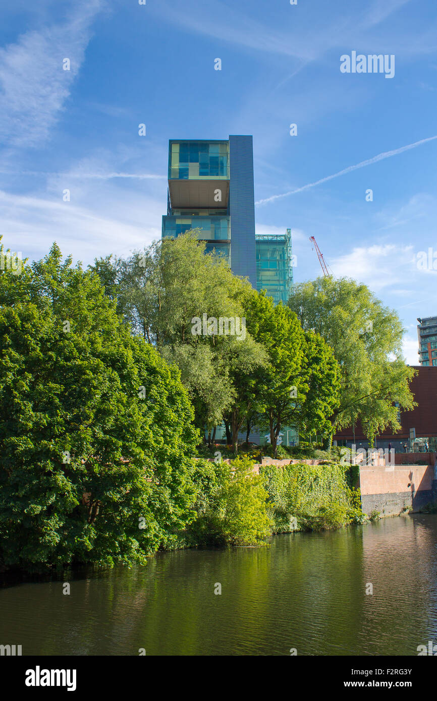 Manchester cityscape along River Irwell. High rise buildings and blue ...