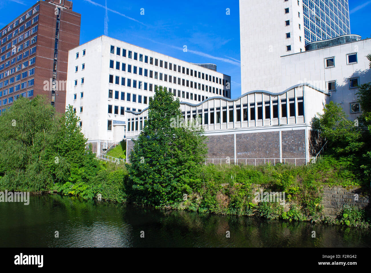 Manchester cityscape along River Irwell. High rise buildings and blue ...