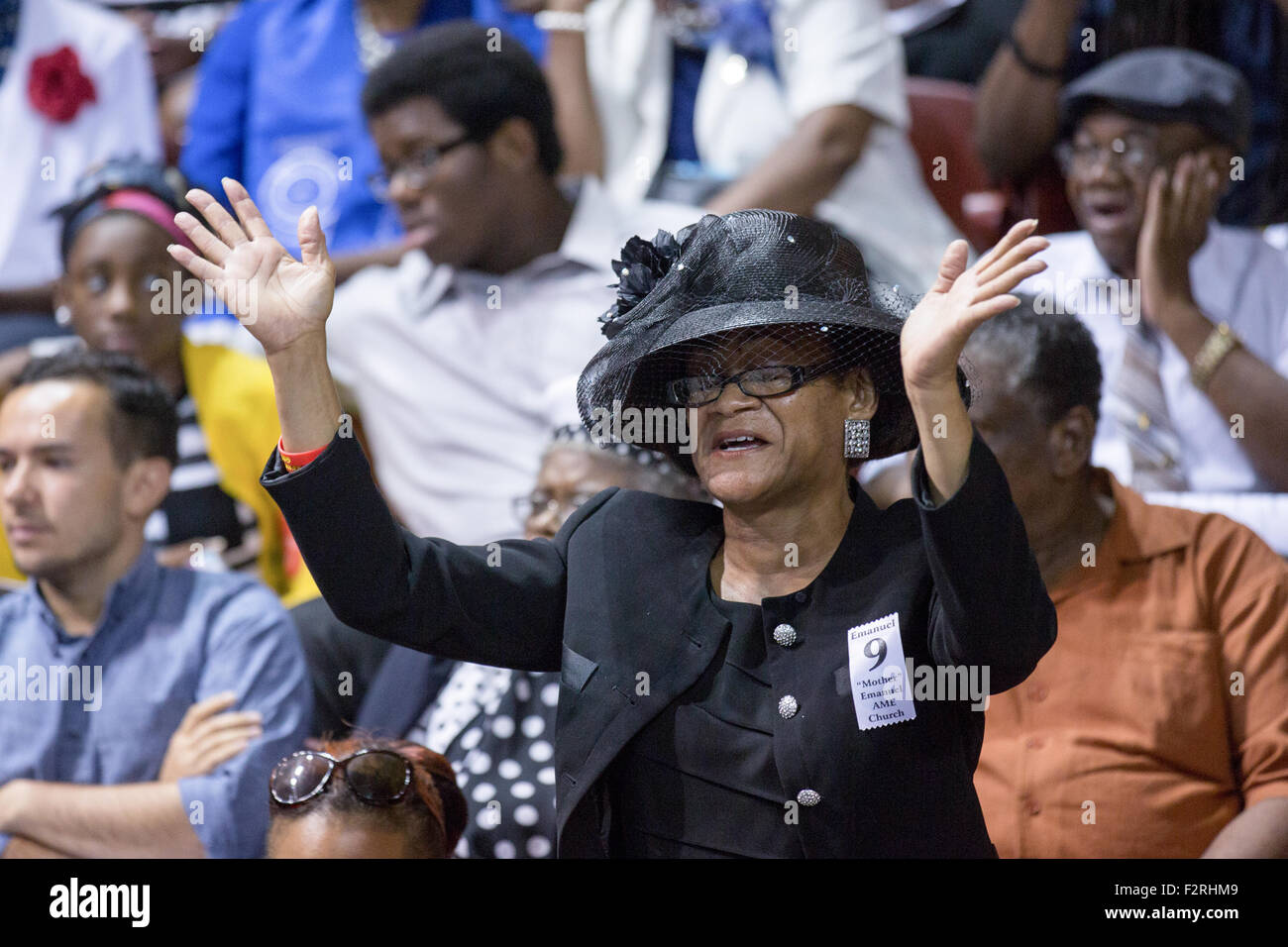 A mourner stands for a hymn during the funeral of slain State Senator ...