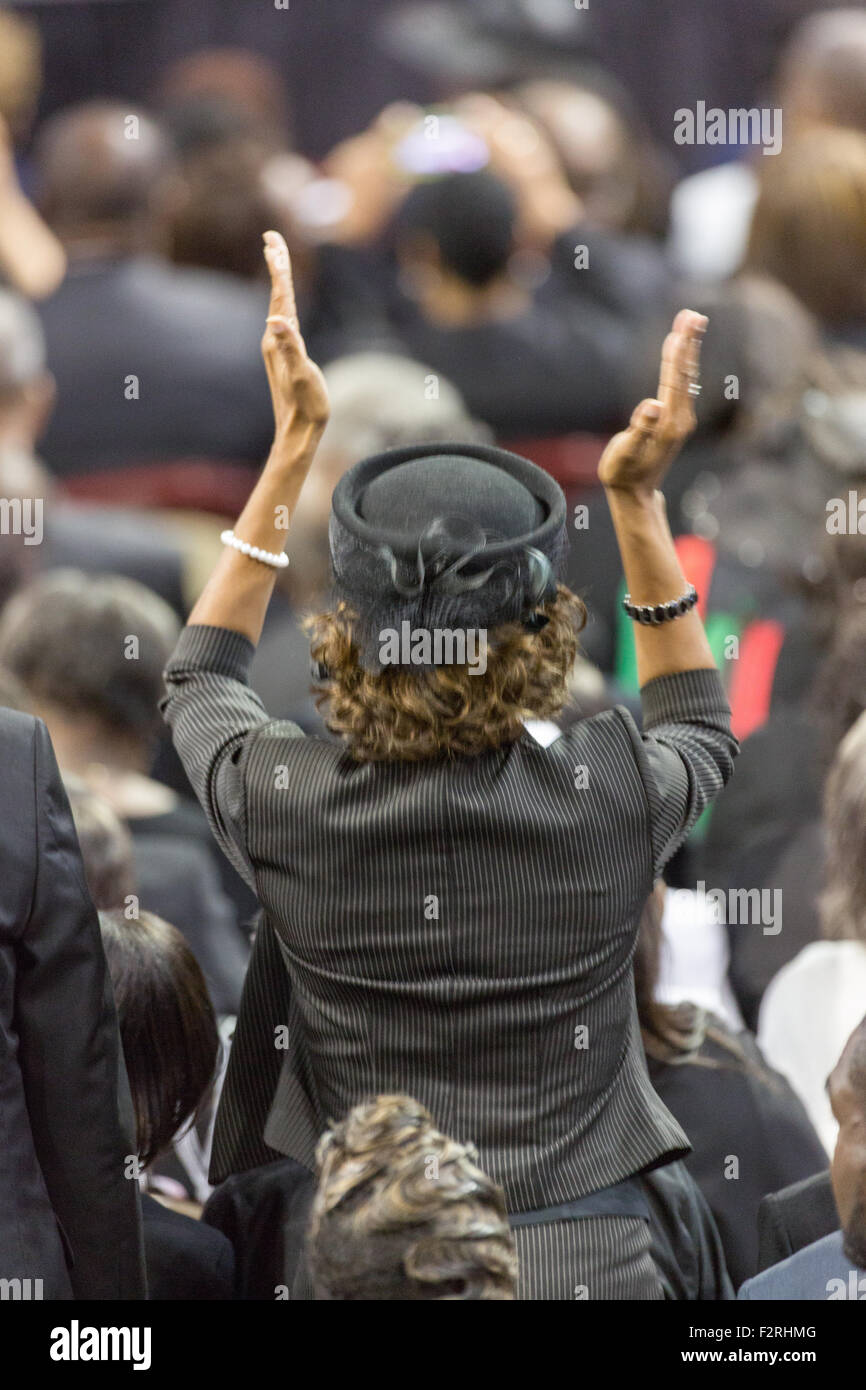 A mourner stands for a hymn during the funeral of slain State Senator ...