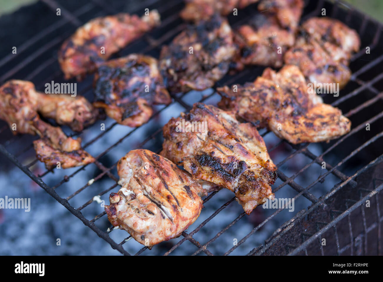 Roasted barbecue meat on charcoals of grill. Recipe or menu BBQ ...