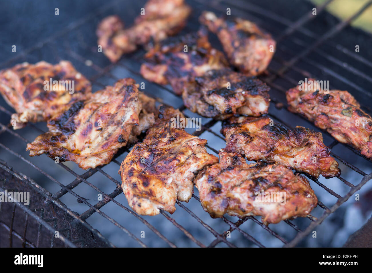 Roasted barbecue meat on charcoals of grill. Recipe or menu BBQ ...